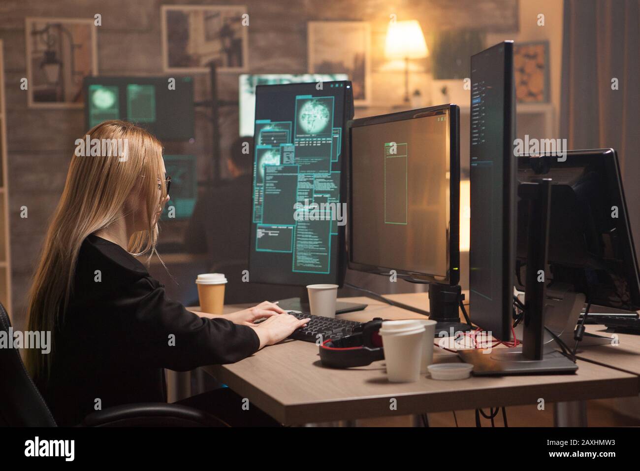 Dangerous female hacker writing a virus on computer to steal credit ...