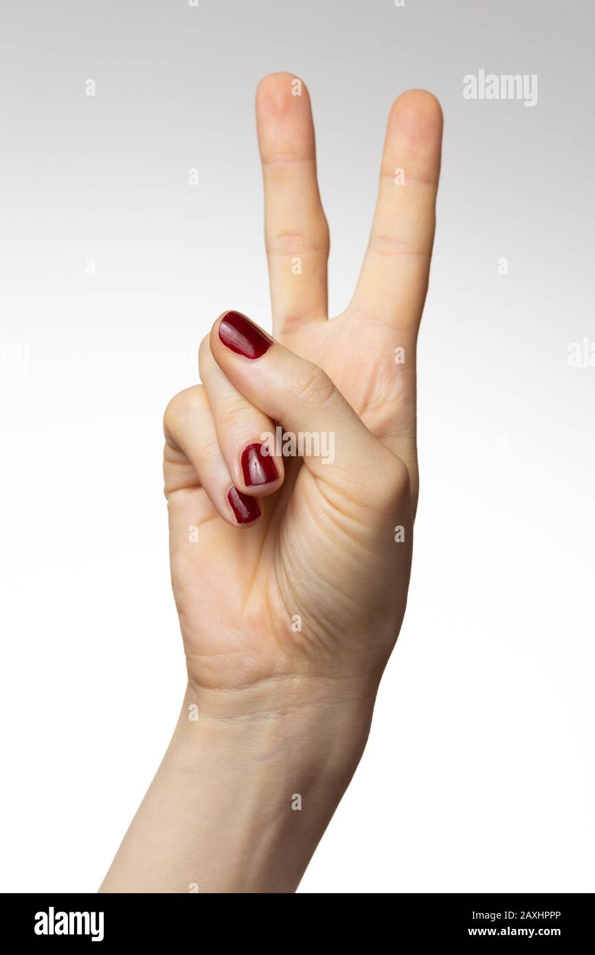 Vertical shot of a female hand with a peace hand sign Stock Photo - Alamy