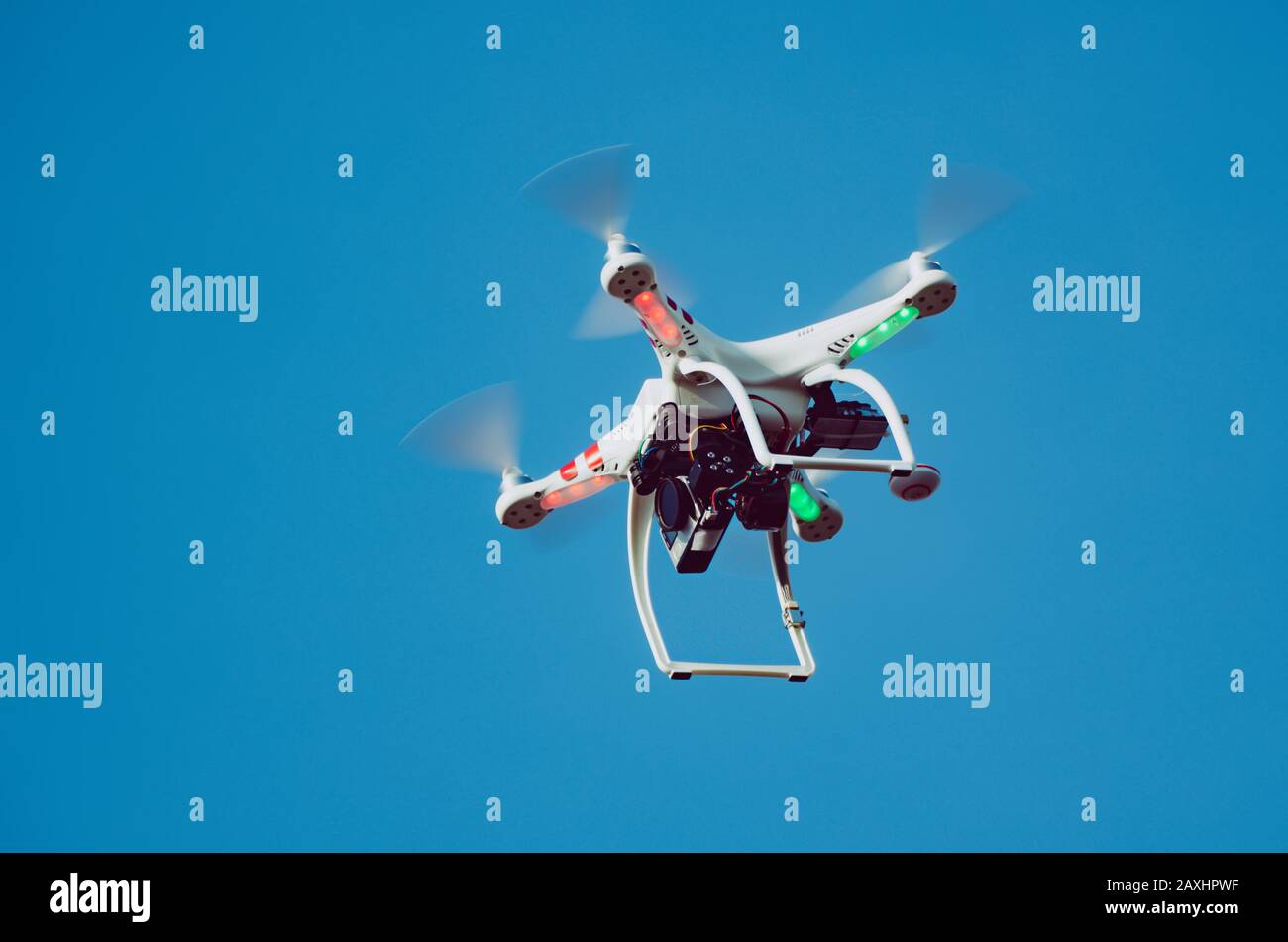 Single drone quadrocopter flying in the blue sky Stock Photo - Alamy