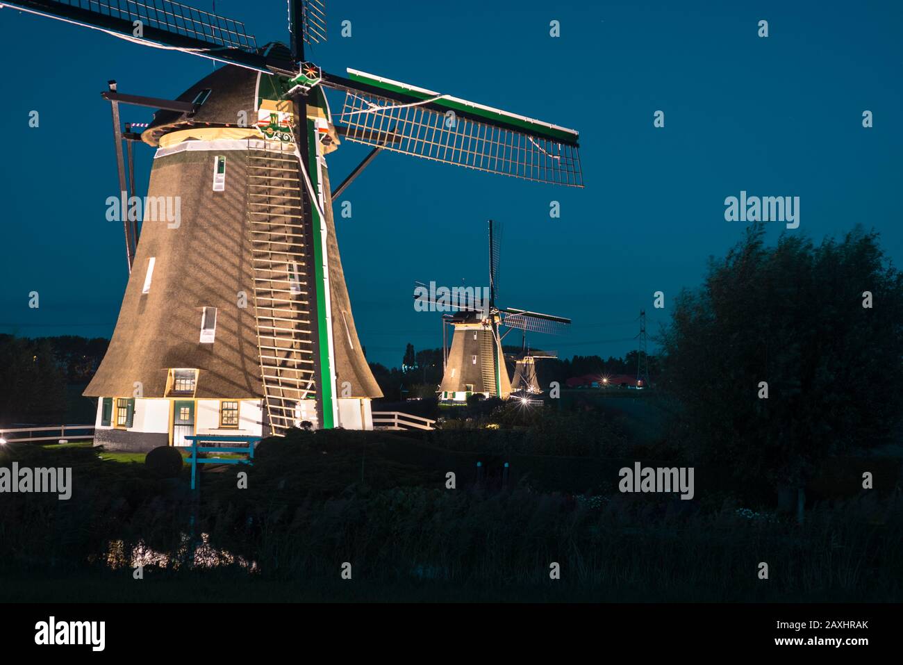 Beautiful landscape image of three illuminated windmills in a row Stock ...