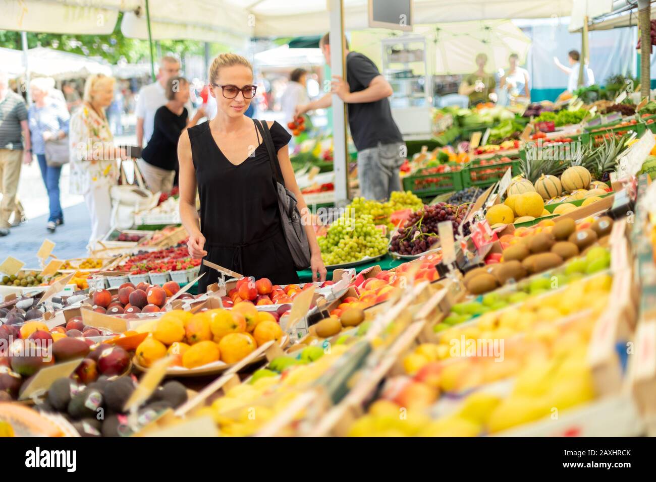 Woman buying fruits and vegetables at local food market. Market stall ...