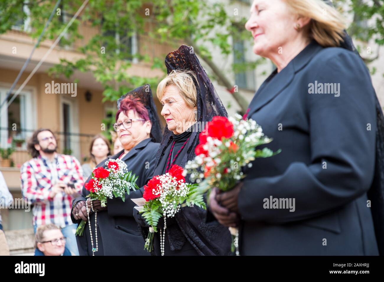Holy Thursday procession of church brotherhood penitents. Women in ...