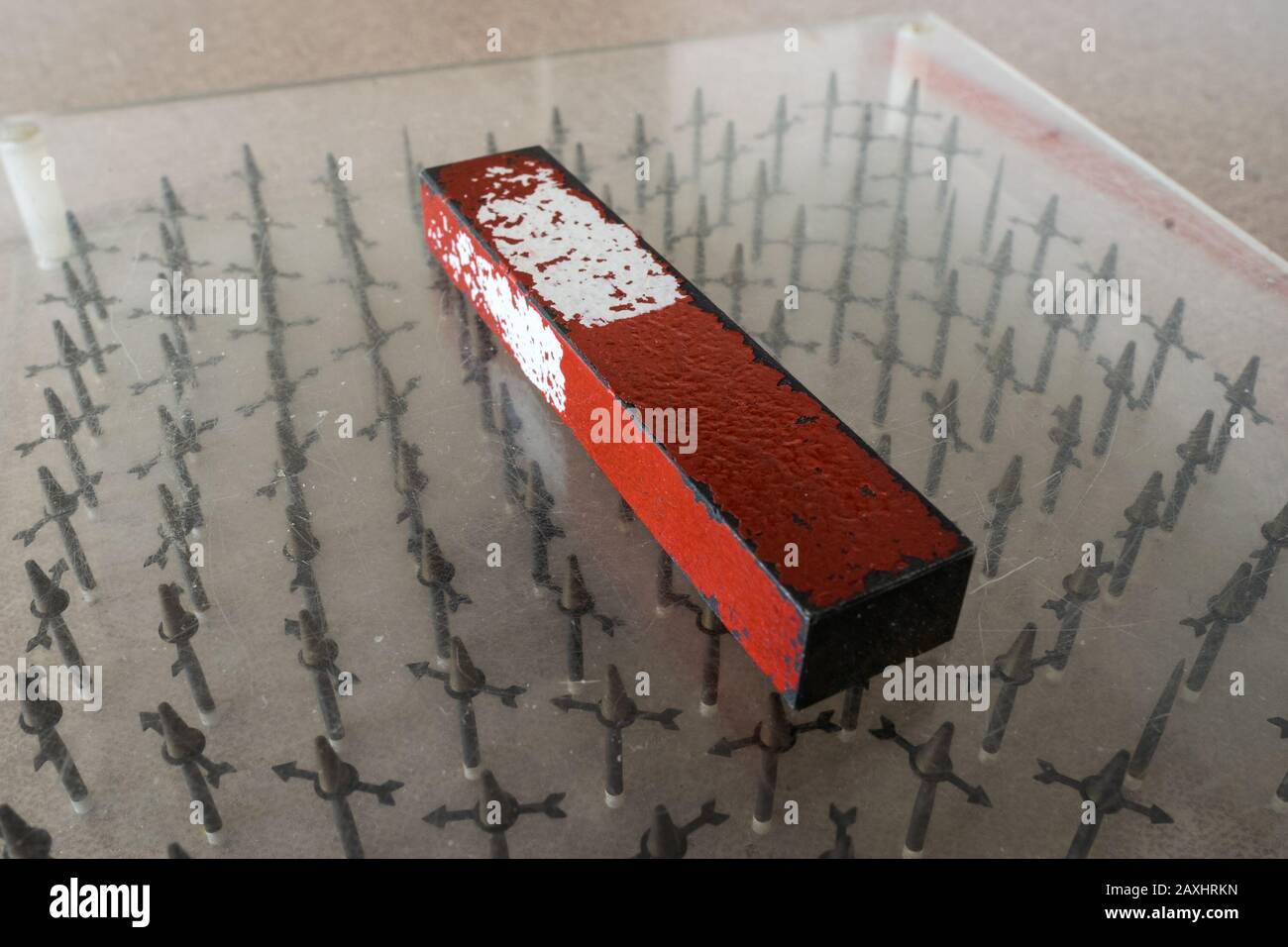 Magnet on board with compasses showing the direction of magnetic field ...