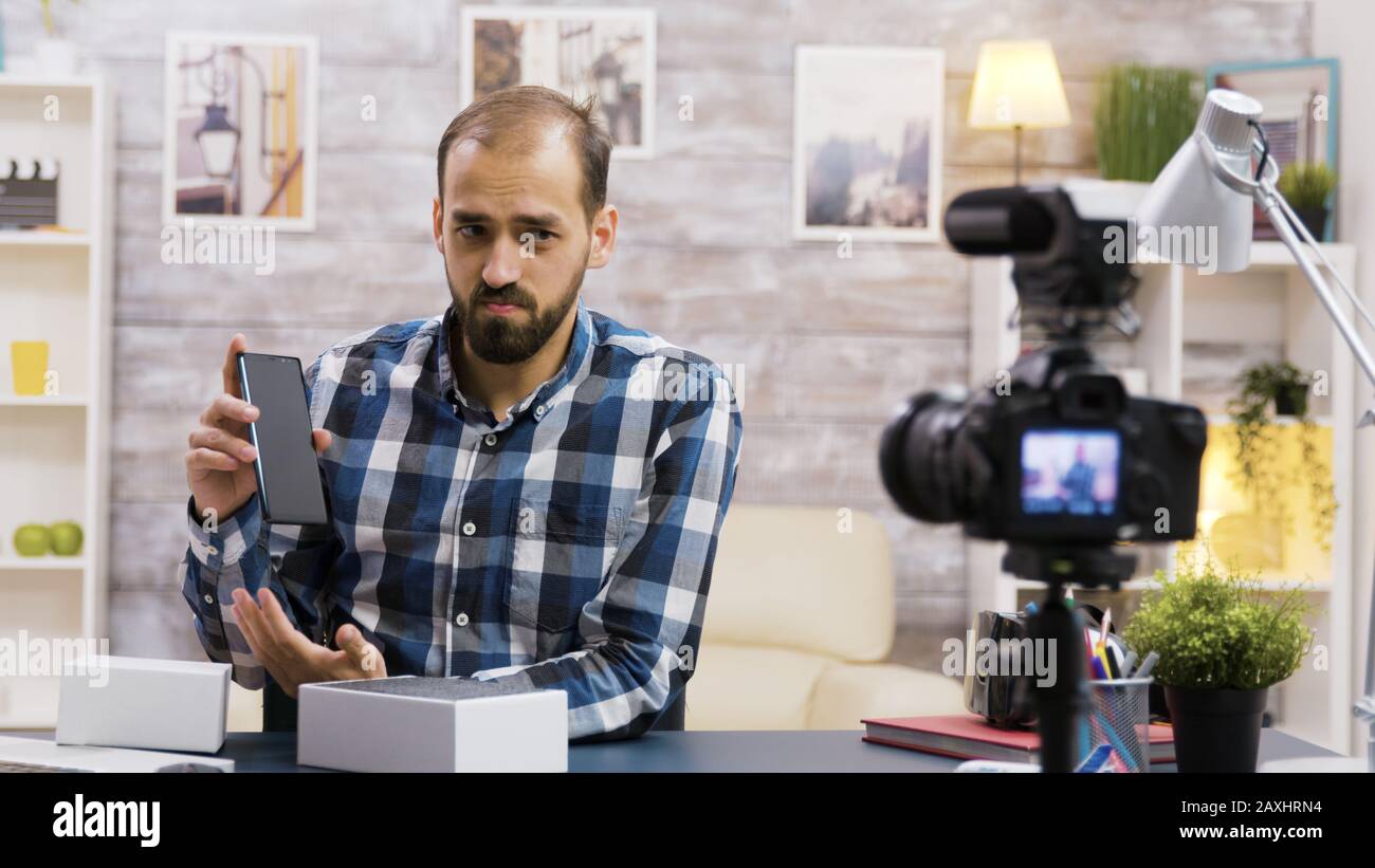 Famous vlogger filming the unboxing of a phone. Creative influencer ...