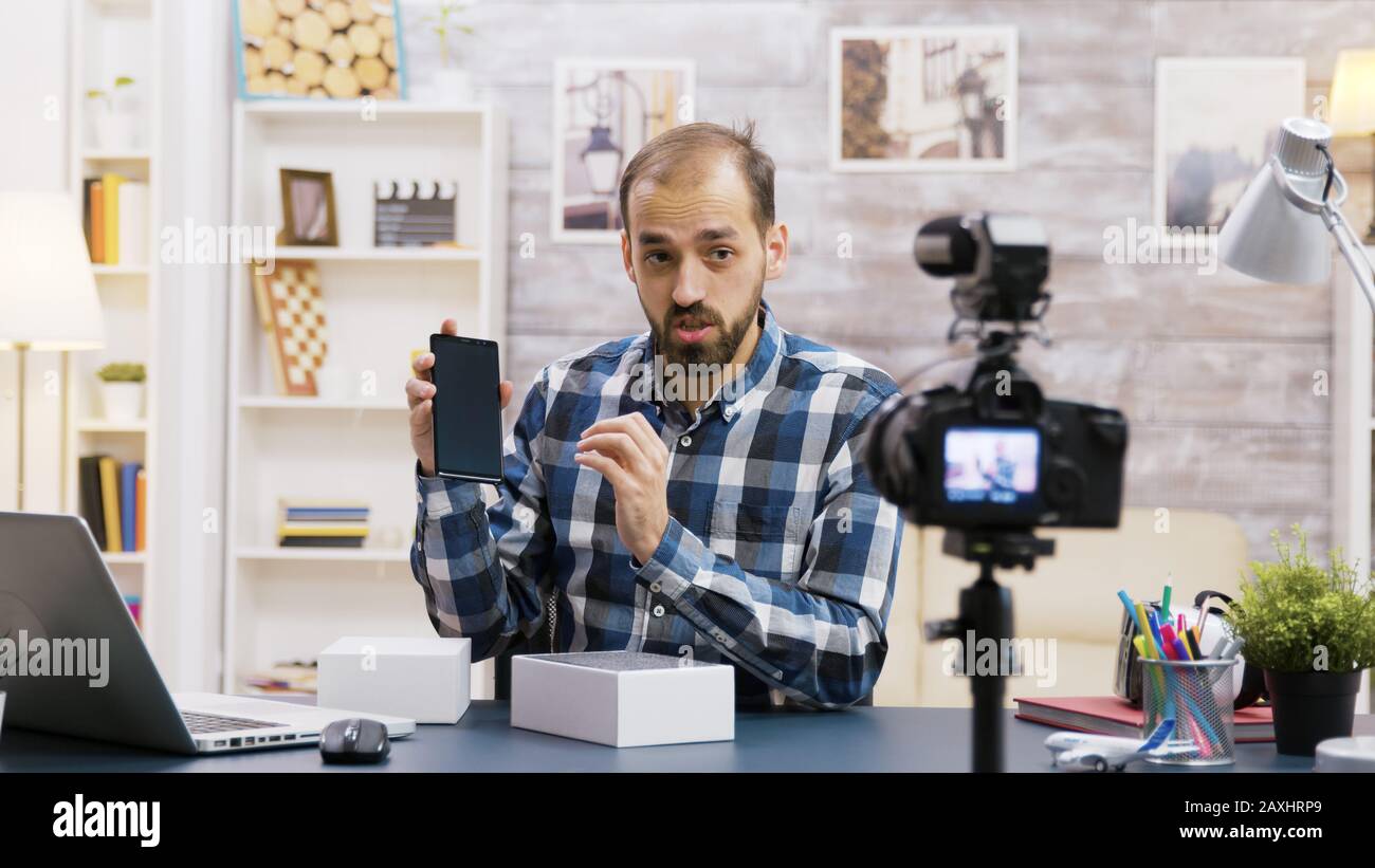 Famous young influencer recording the unboxing of a phone. Creative ...