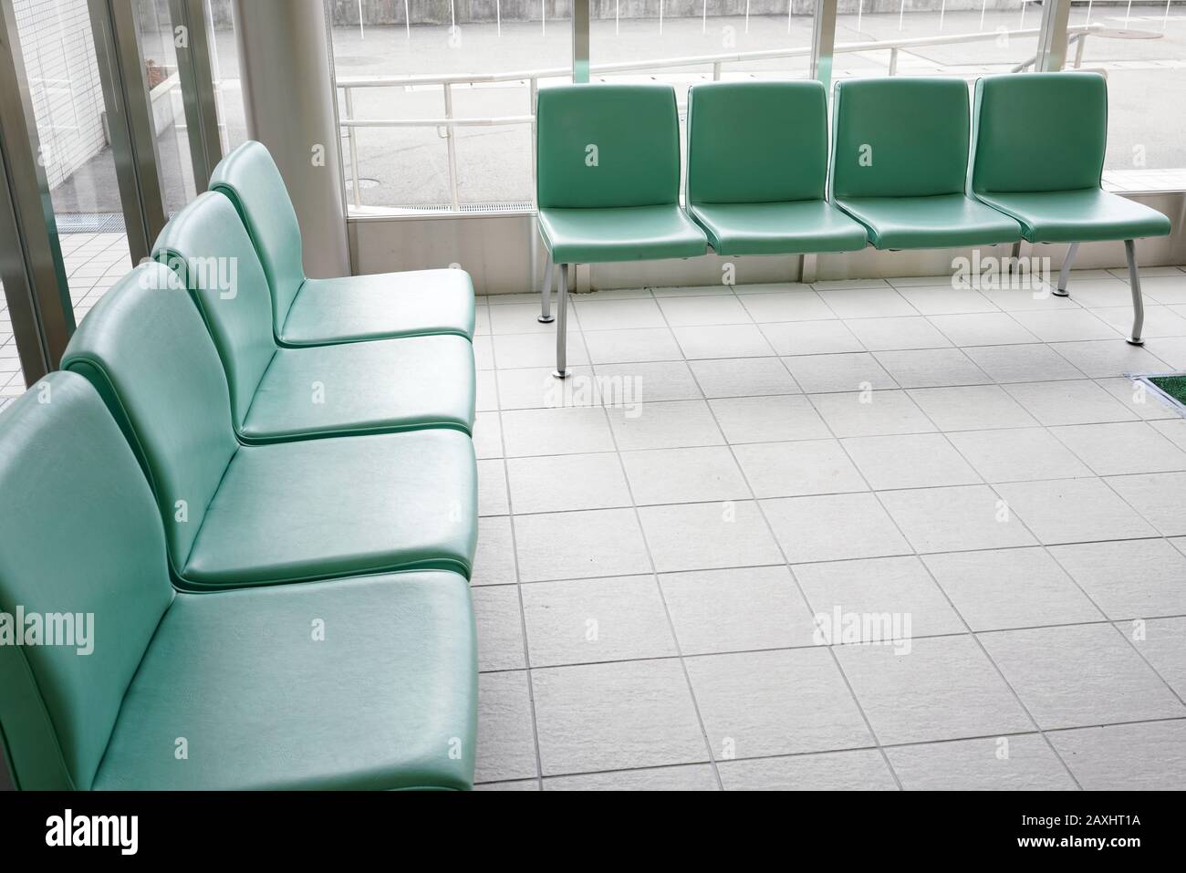 Hospital waiting room with empty green chairs Stock Photo - Alamy