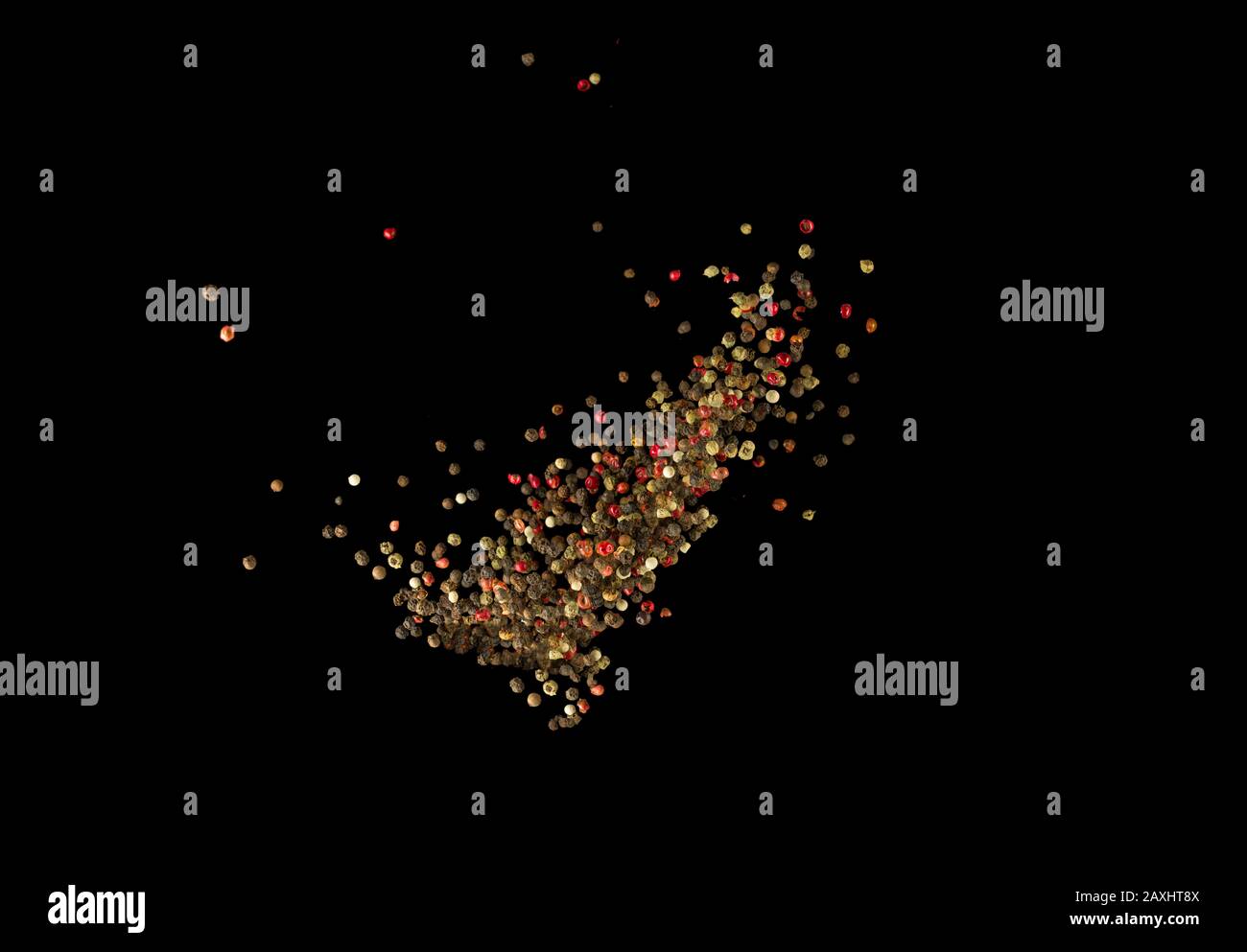 Whole coloured pepper spice flying in the air. Zero gravity concept ...