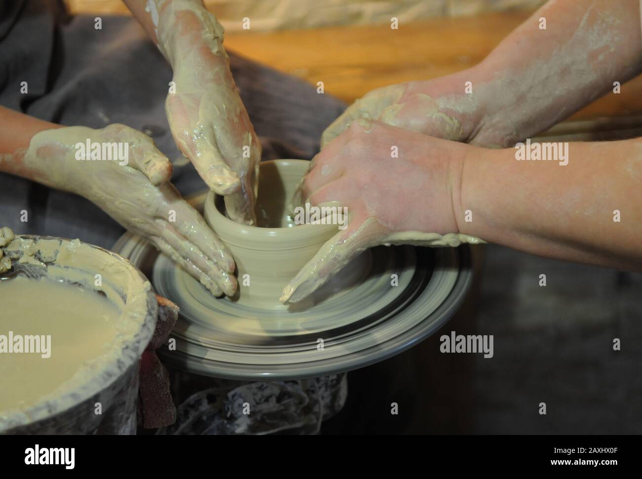 Pottery lesson, only hands are visible. Everything is in clay Stock ...