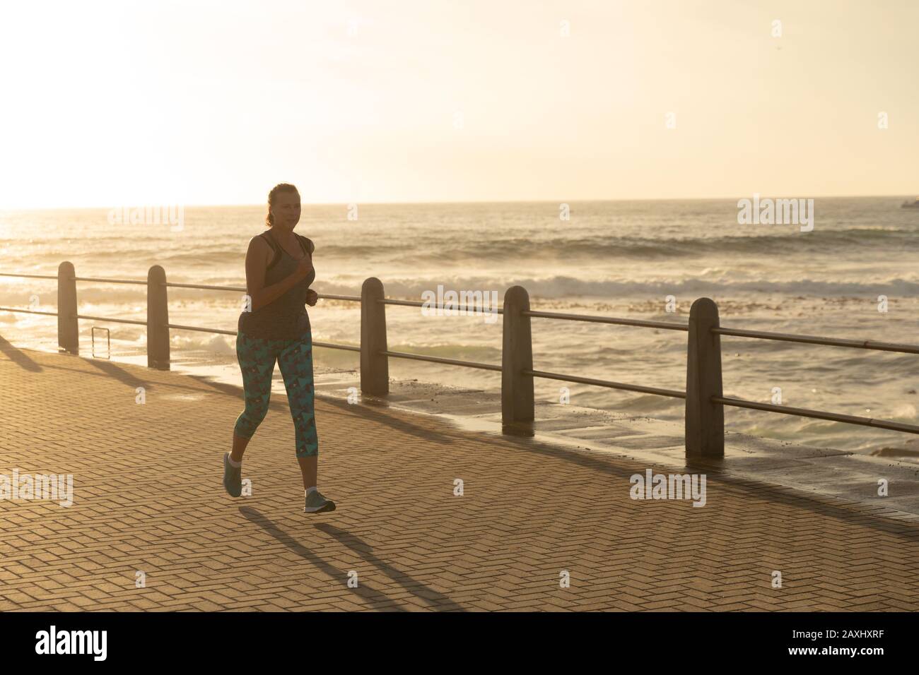 Female runner at sunset hi-res stock photography and images - Alamy