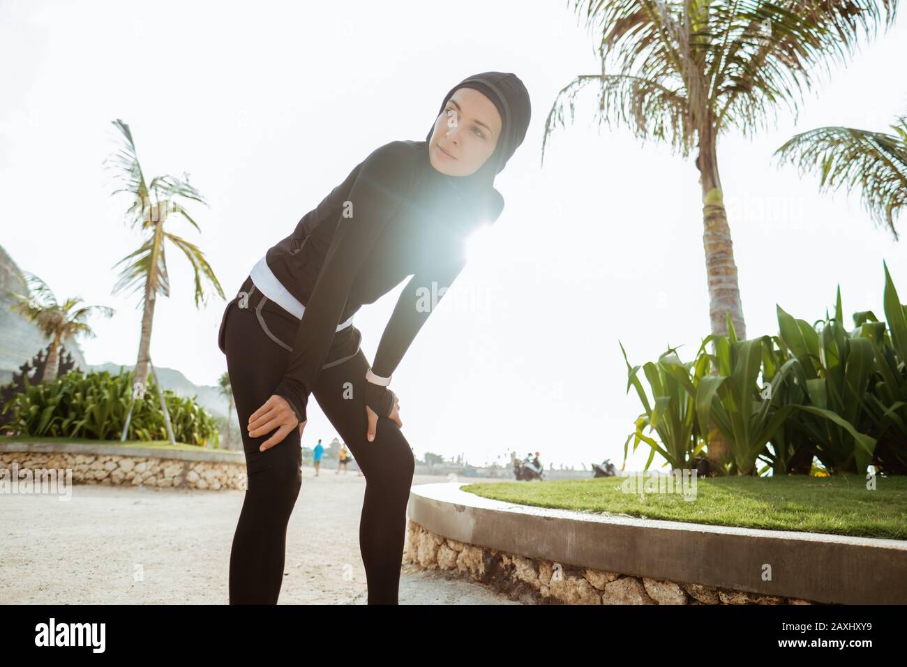 Fitness sport muslim girl resting after intensive run, young attractive ...