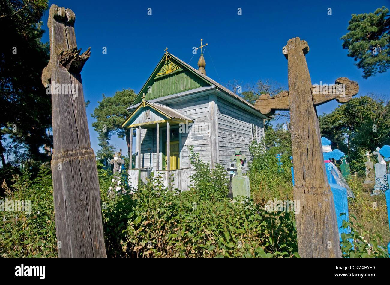 Old wooden church and grave crosses in cemetery. Volin region Stock ...
