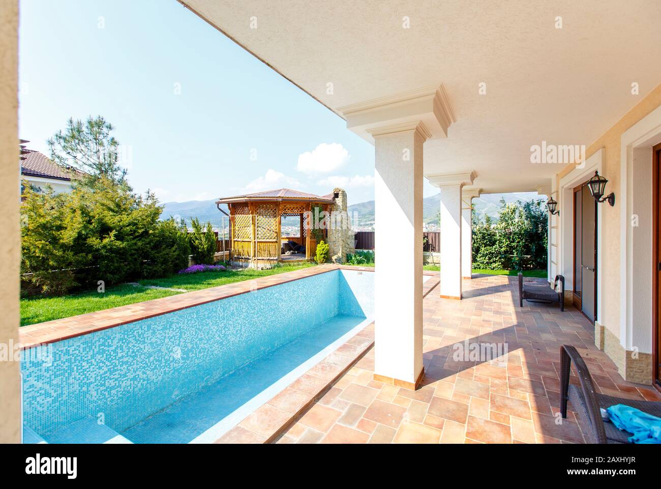 Veranda with white columns and beige tiles on the first floor of the ...