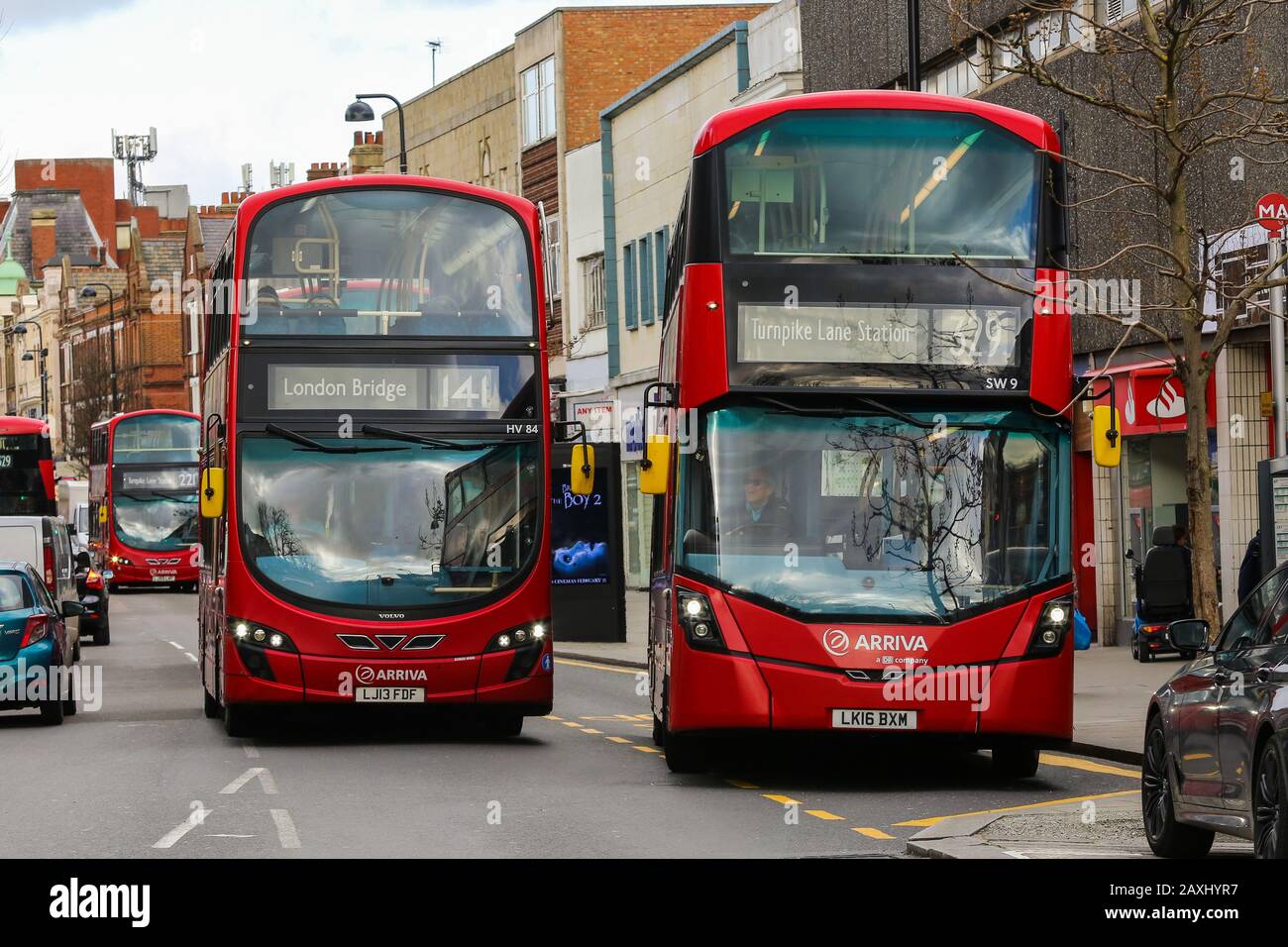 Red hybrid London buses on a busy London road Stock Photo - Alamy