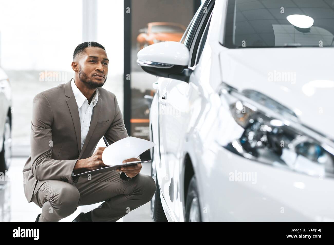 Insurance Agent Checking Car Taking Notes In Dealership Store Stock ...