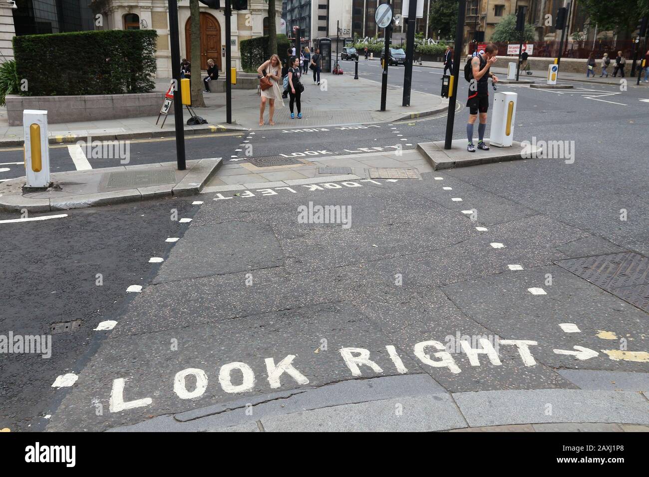 LONDON, UK - JULY 8, 2016: People cross a street in London. The "look ...