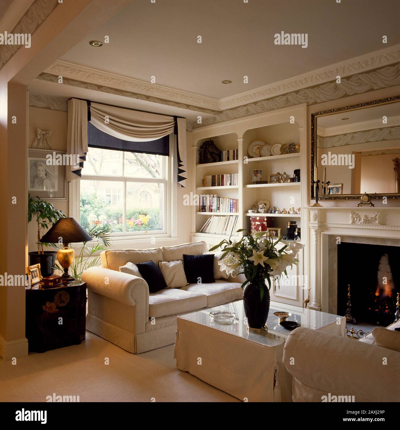 Designer drawing room with open fire Stock Photo - Alamy
