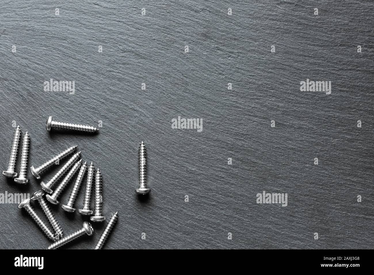 Stainless steel wood screws on a black texture background Stock Photo ...