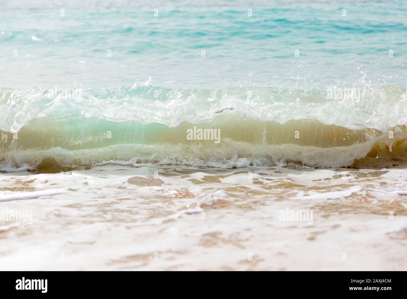 Close up sea waves with splashes on sand beach. Close up Stock Photo ...