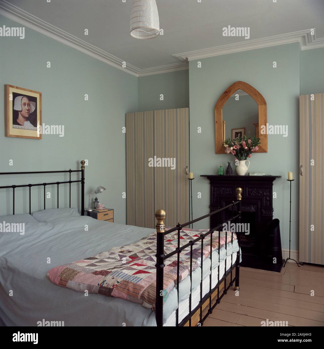 Traditional bedroom with metal bedstead Stock Photo - Alamy