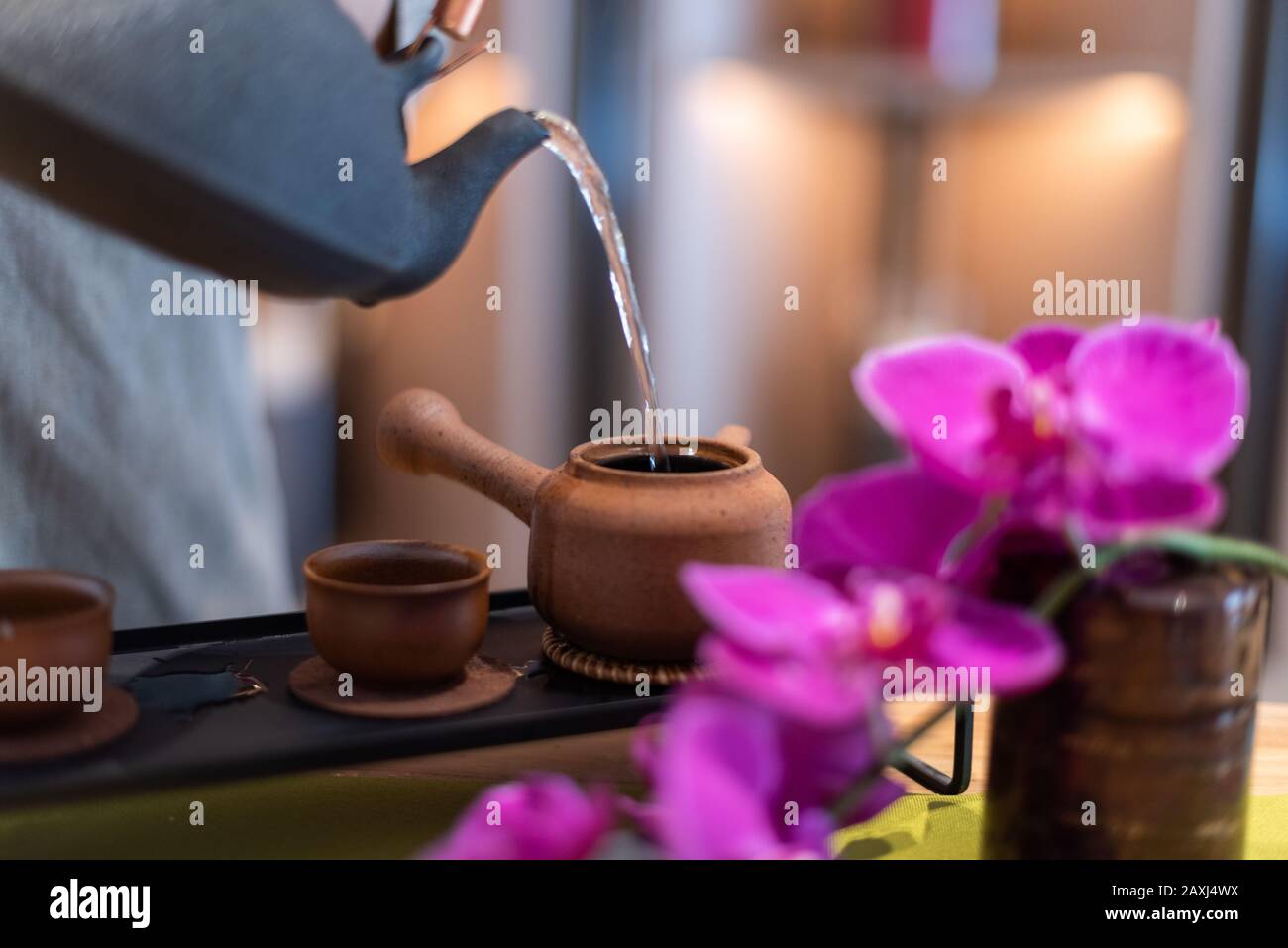 Traditional Chinese tea Set up with orchid and pebbles Stock Photo - Alamy