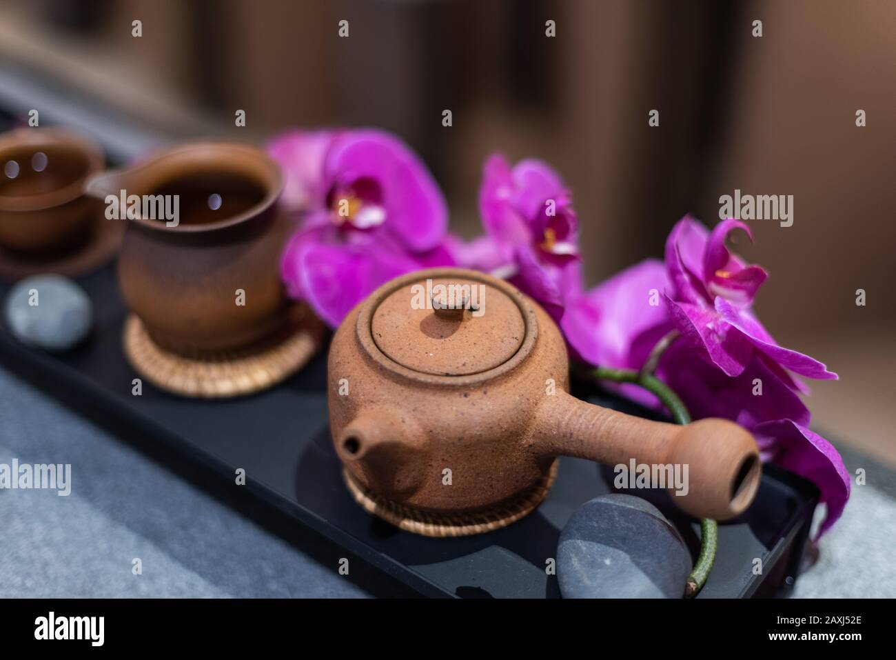 Traditional Chinese tea Set up with orchid and pebbles Stock Photo - Alamy
