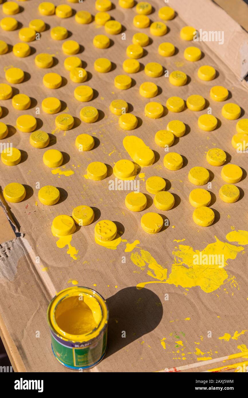 Yellow painted wooden discs used for playing Singapore checkers, a ...