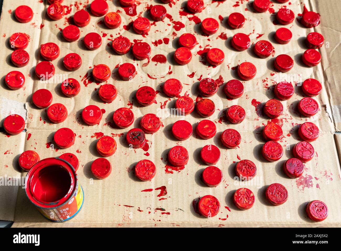 Red painted wooden discs used for playing Singapore checkers, a popular ...