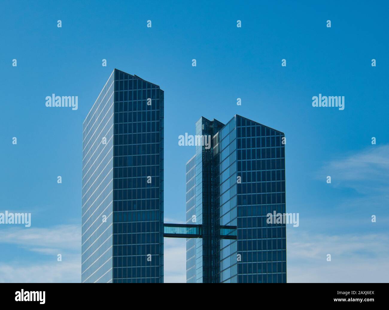 Two free-standing high-rise buildings with a connecting bridge on the ...