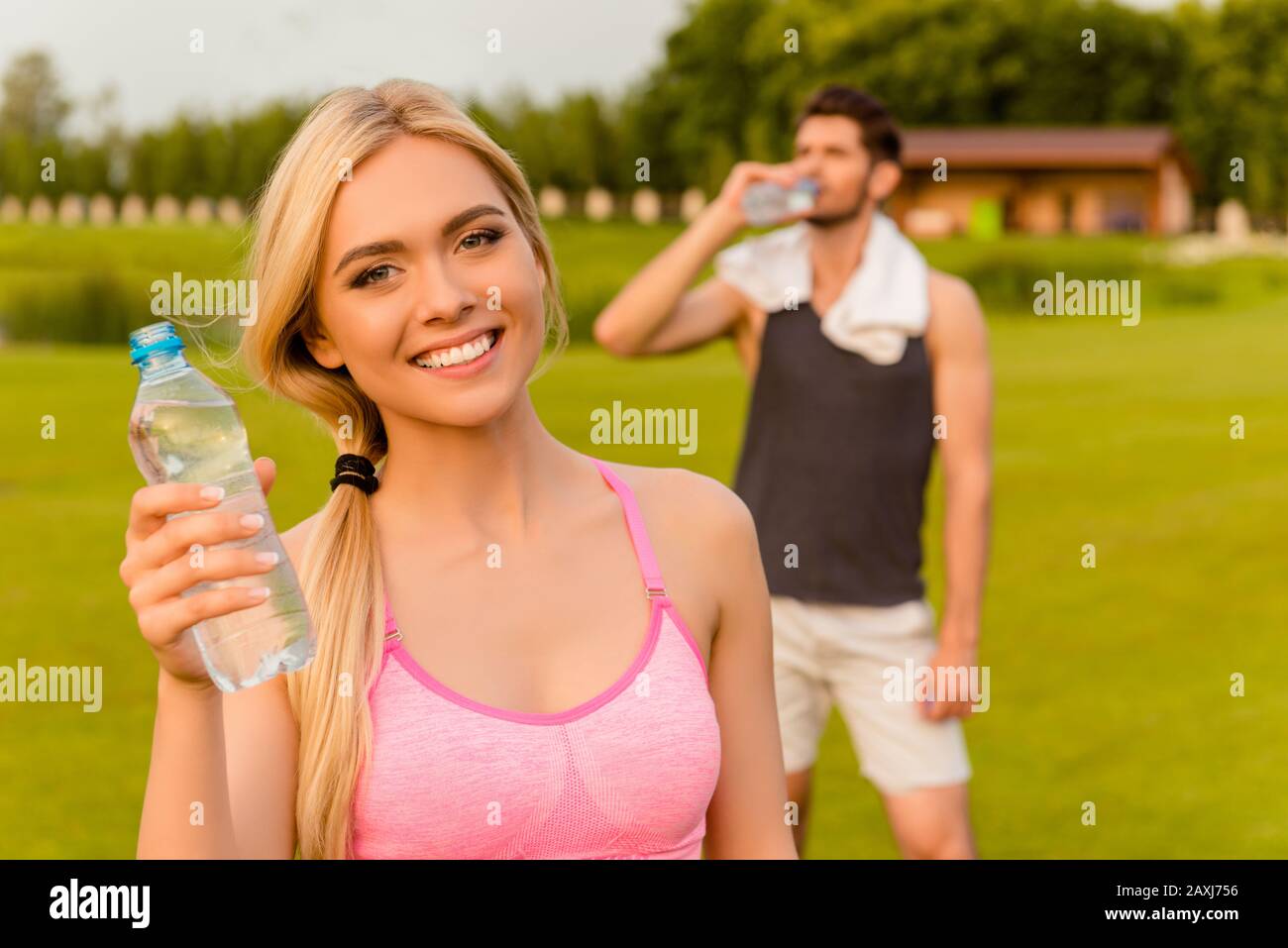 Portrait of pretty smiling woman holding bottle of watter. Her ... Portrait of pretty smiling woman holding bottle of watter. Her ...
