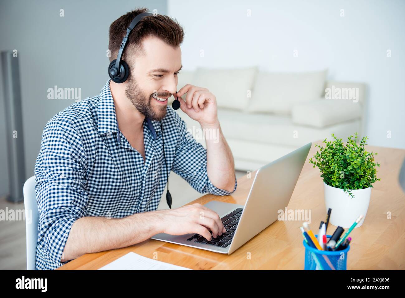 Happy cheerful young worker of call center in head-phones smiling Stock ...