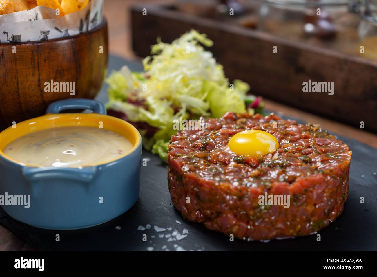 French Beef Tartare dish set with rustic background Stock Photo - Alamy