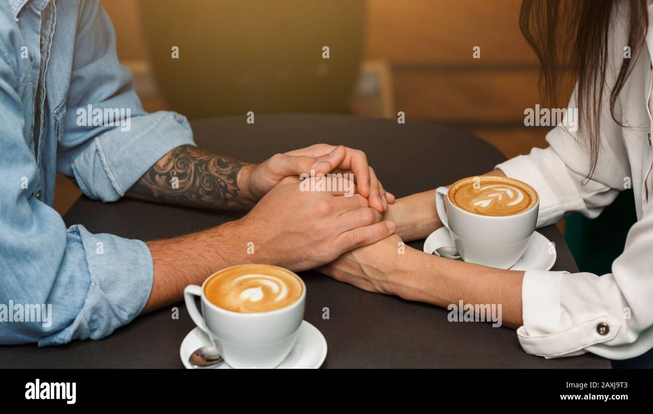 Unrecognizable Couple Holding Hands During Romantic Date In Cafe ...