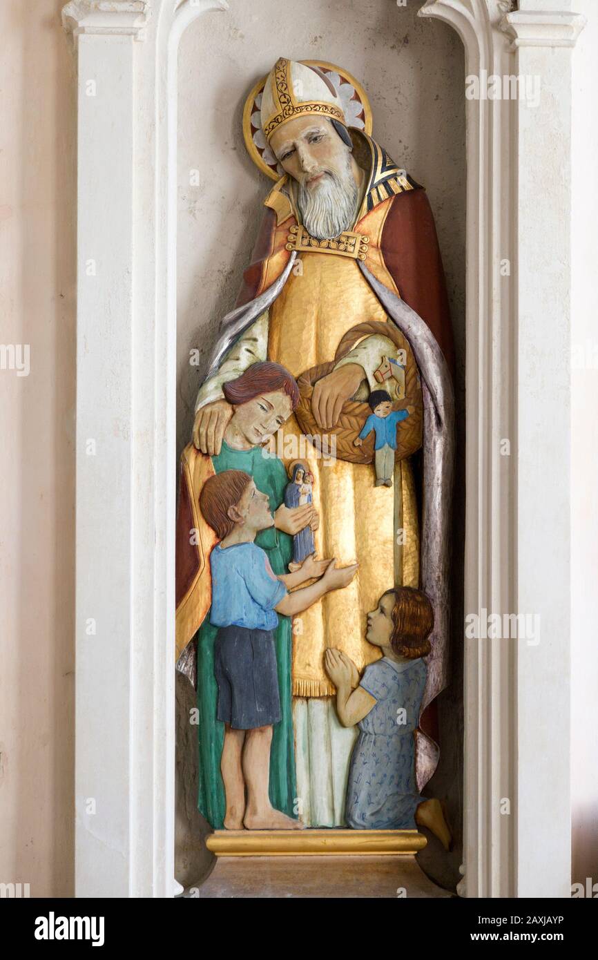 Sculpture statue of Saint Nicholas with children inside village parish ...