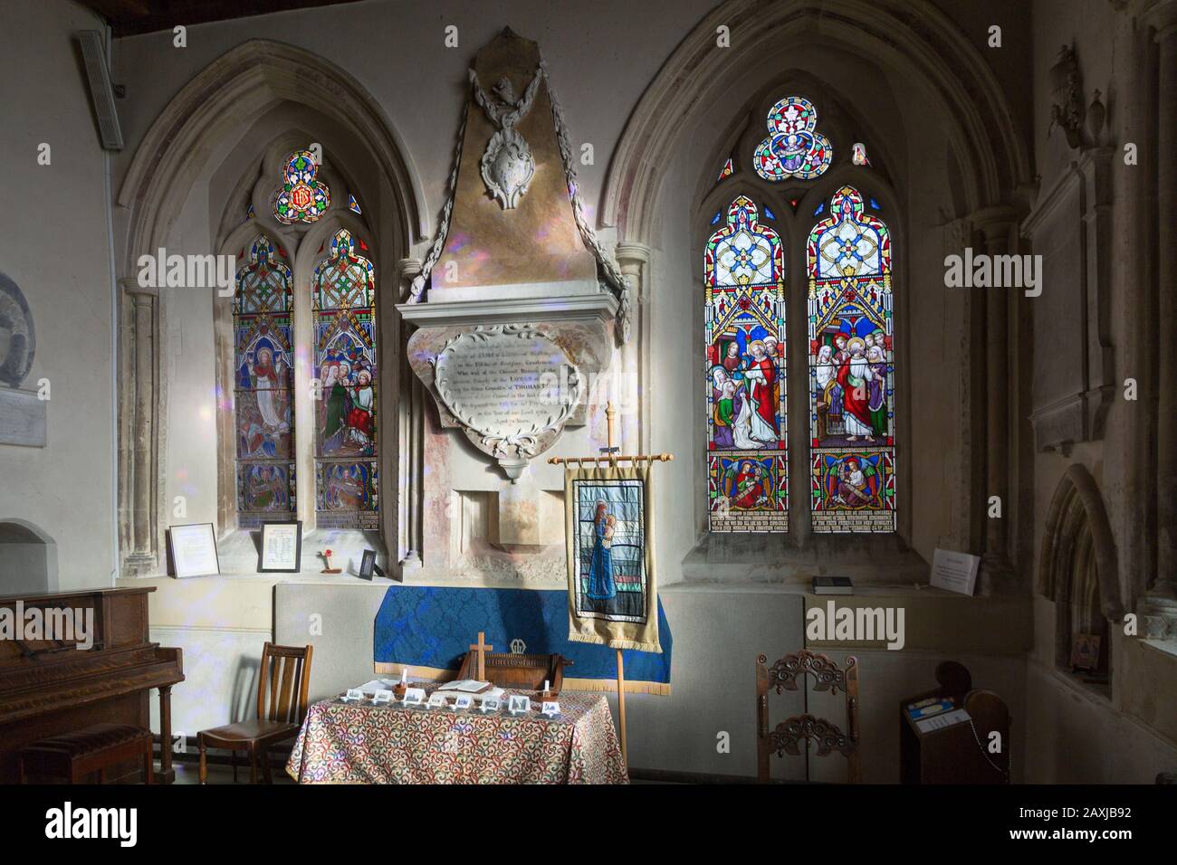 Side chapel altar, stained glass windows inside the church at Urchfont ...