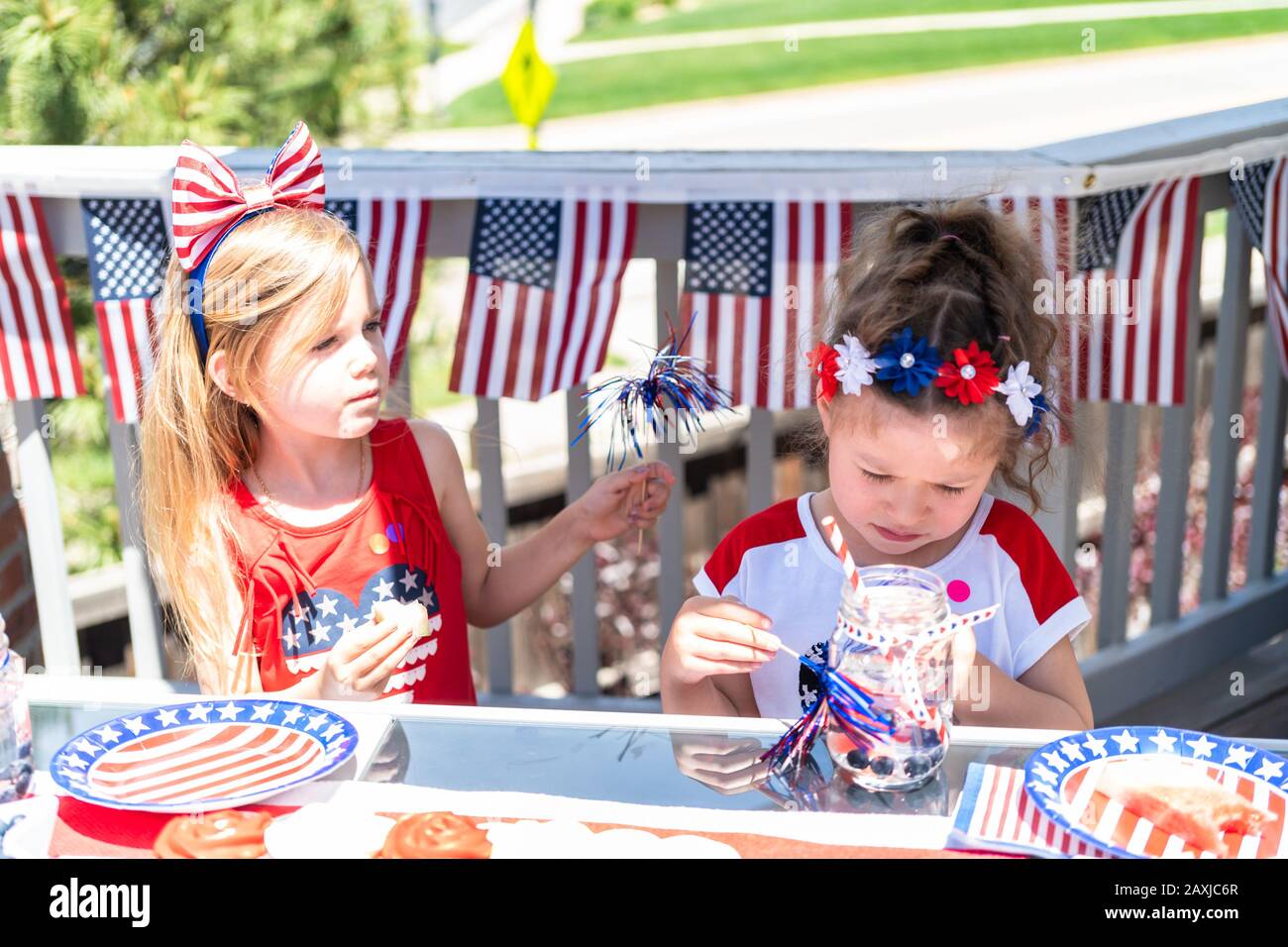 Little girls are playing at the July 4th party on the back patio Stock ...