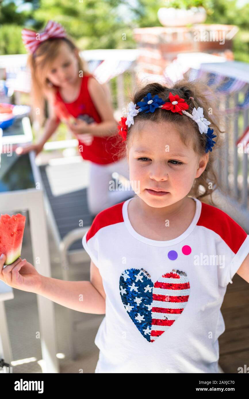Little girls are playing at the July 4th party on the back patio Stock ...