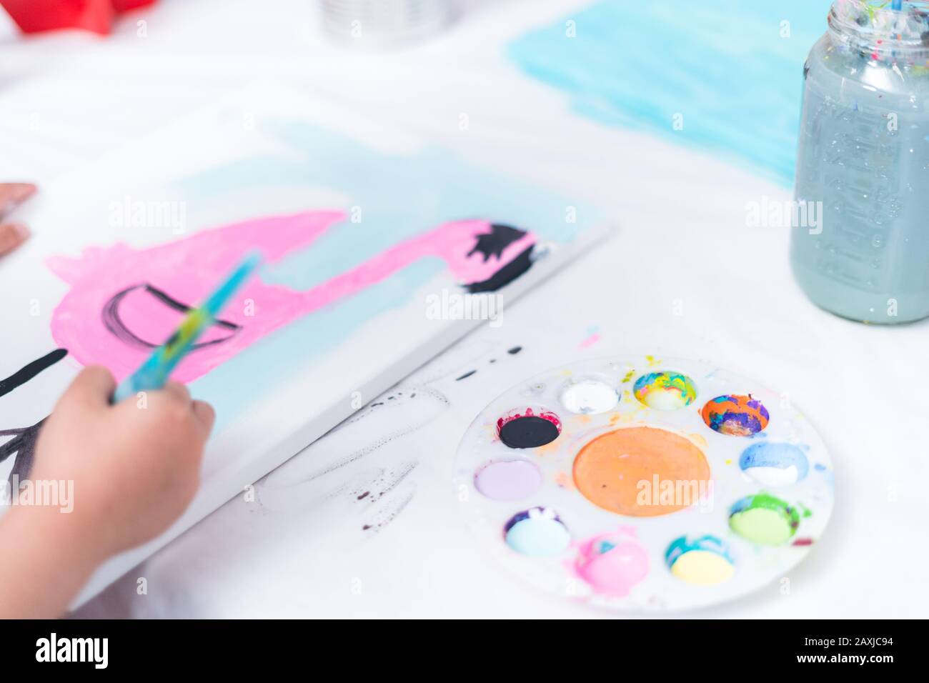Little girls are painting on canvas with acrylic paint Stock Photo - Alamy