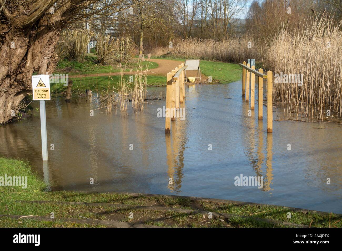 A walkway is submerged as a lake has flooded and submerged the pathway ...