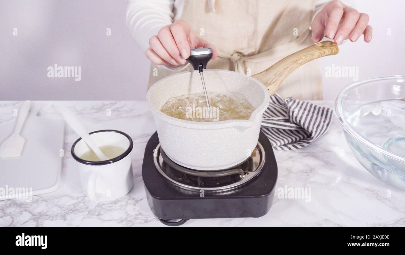 Step by step. Caramelizing sugar in a small cooking pot over the small ...