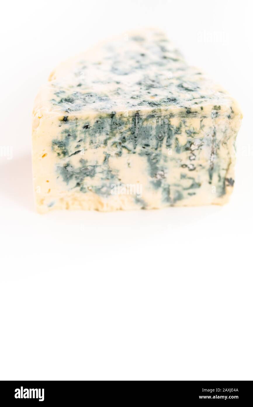 Large slice of blue cheese on a white background Stock Photo - Alamy