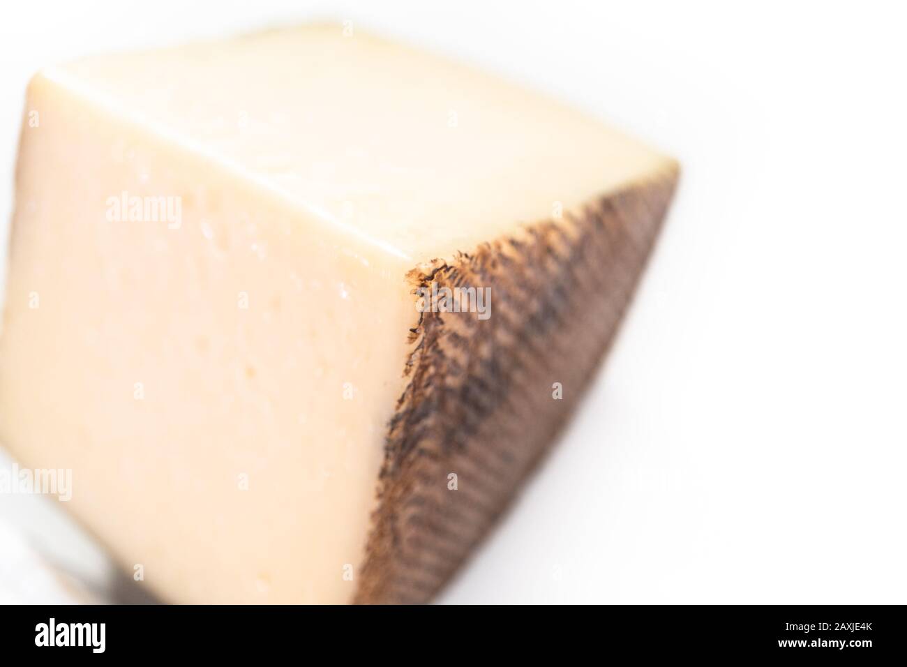 Large slice of aged Manchego cheese on a white background Stock Photo - Alamy
