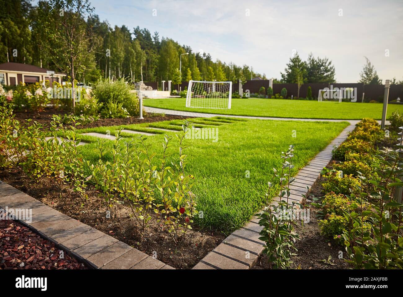 Landscaping. lawn with green grass and a football field Stock Photo - Alamy