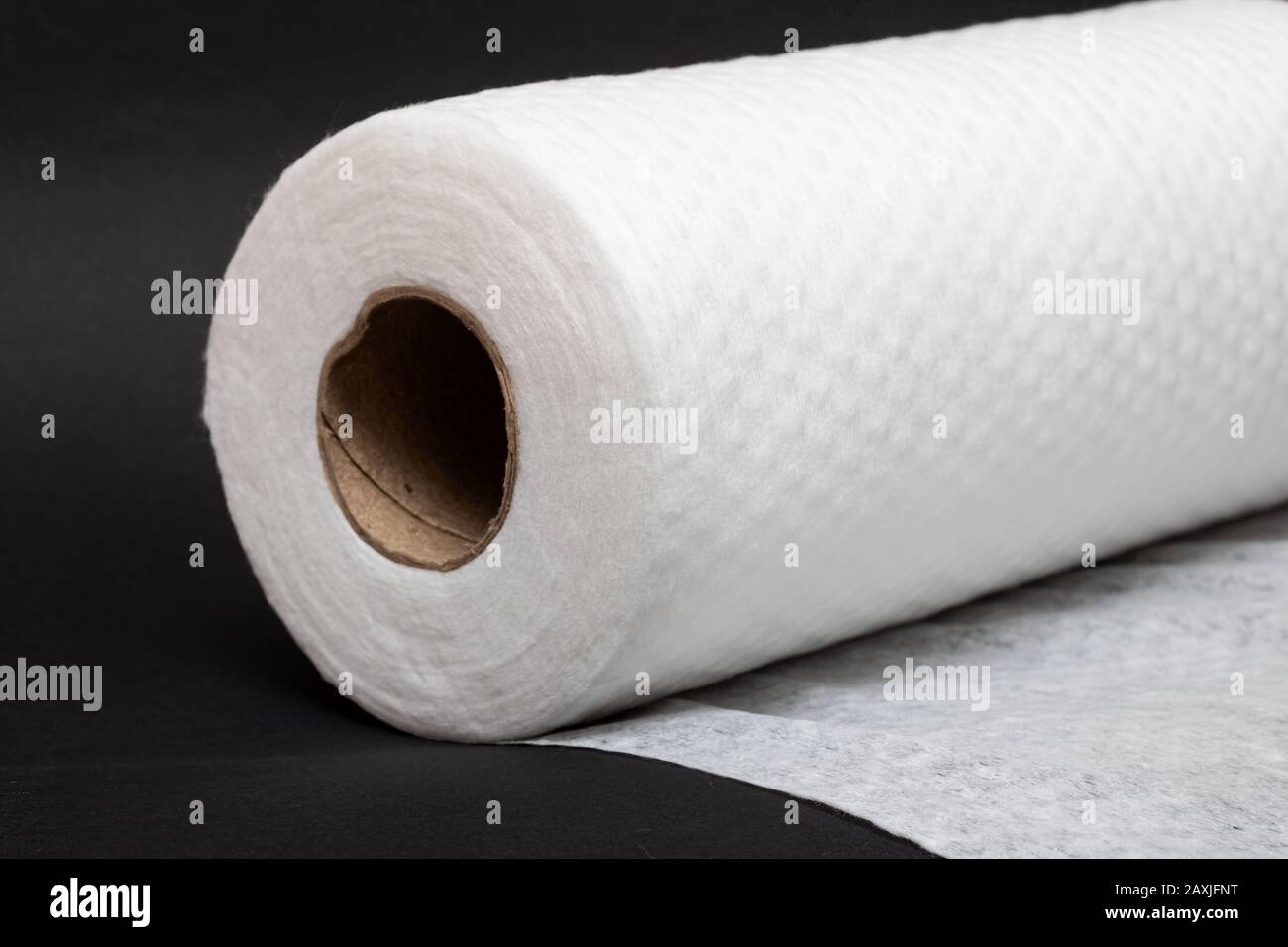 Roll of fabric napkins on a black background Stock Photo - Alamy