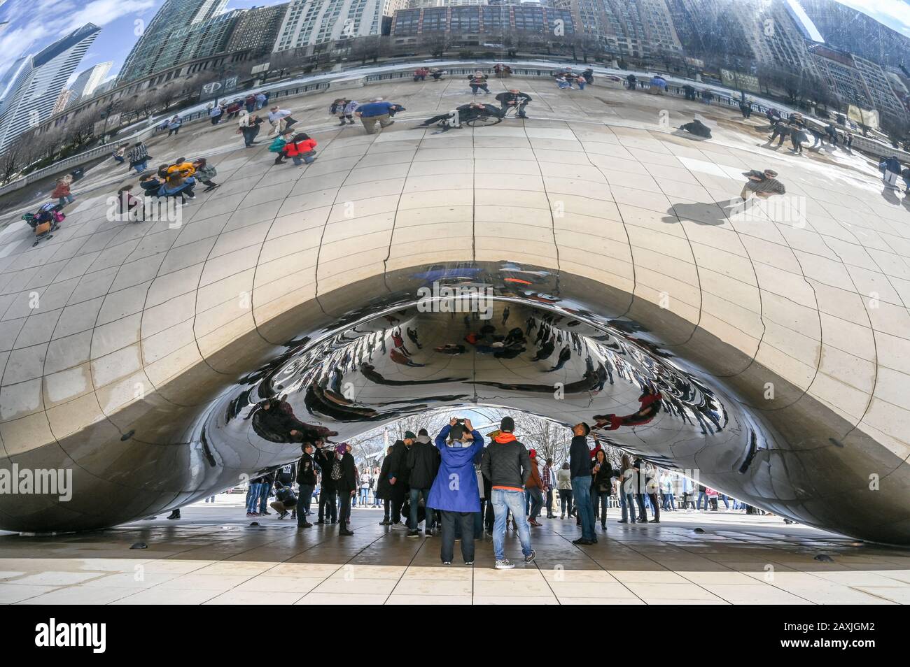 Tourists admire iconic Cloud Gate at Millenium Park during early spring ...