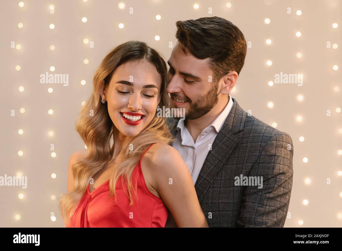 Elegant Couple Bonding And Embracing Together Over Beige Background ...