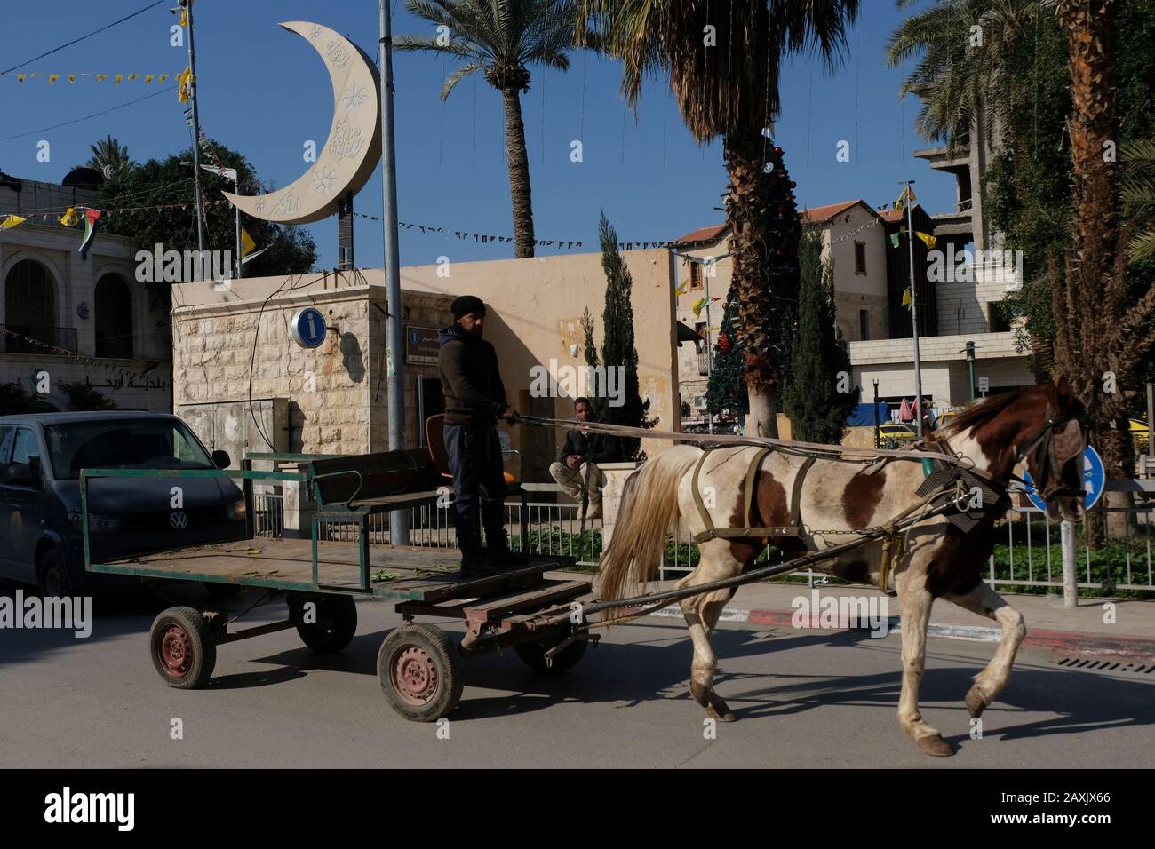 A Palestinian man rides a horse cart in the main square of the city of ...