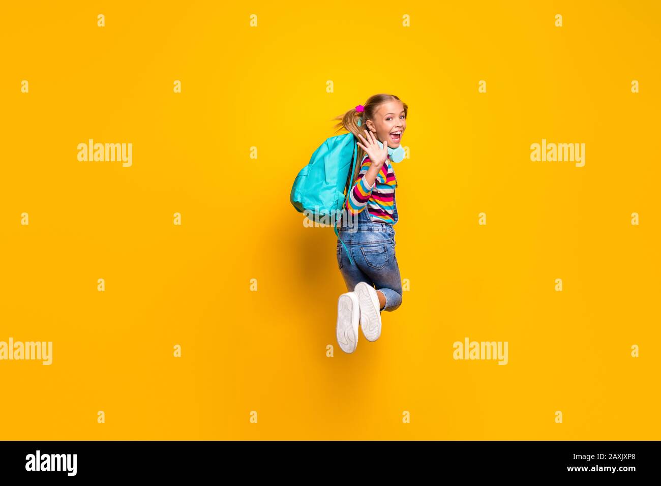 Full body back rear spine photo energetic schoolchild jump wave hand ...