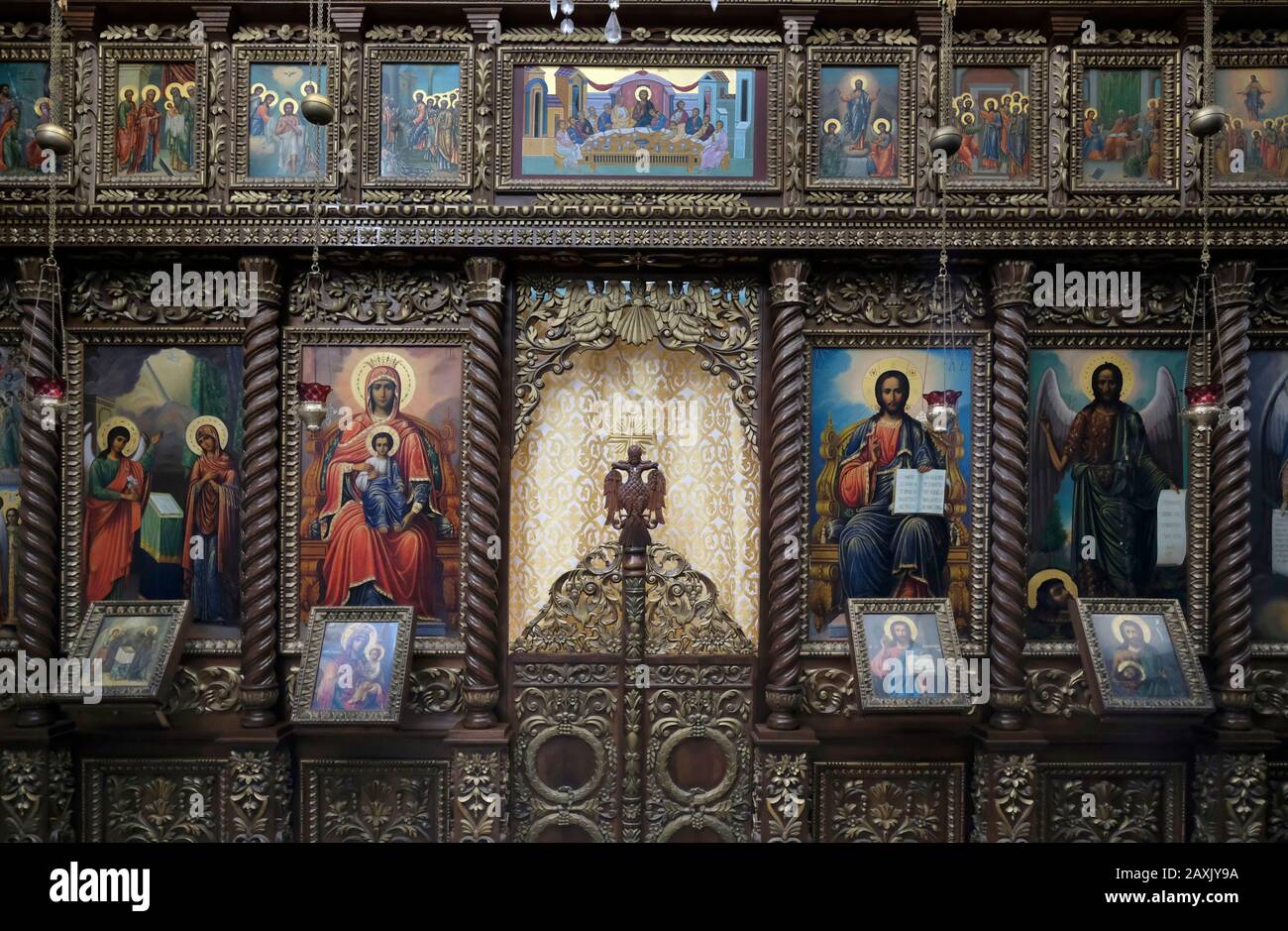 The iconostasis decorated with icons and religious paintings of the nedieval cave church inside ...