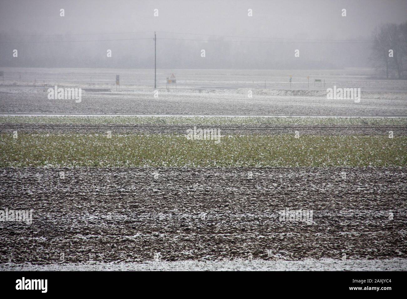 Fields covered with a thin layer of snow, wintry mood, pattern of ...