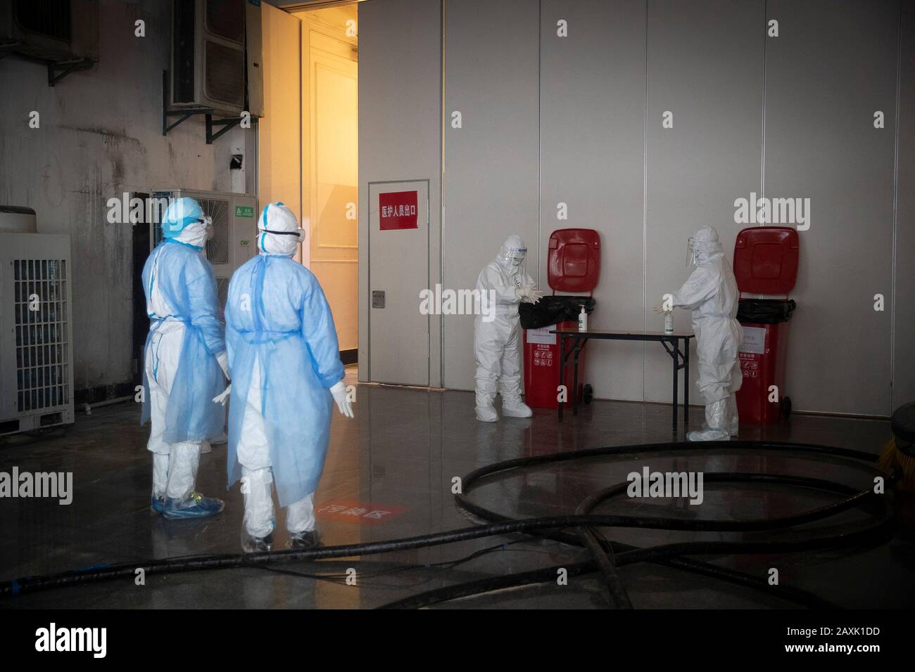 Chinese medical workers wearing protective clothing and surgical face ...